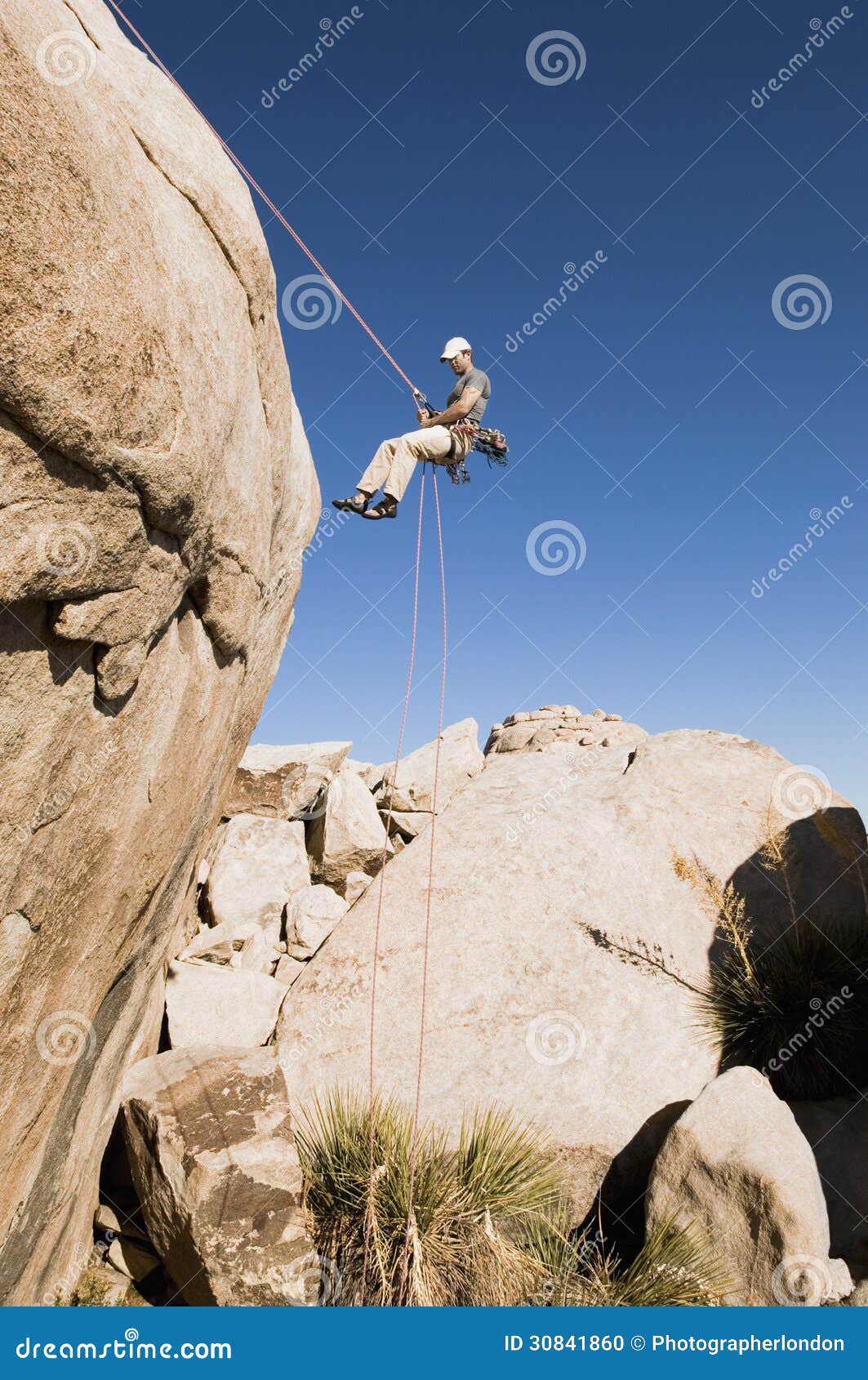 Man Rappelling from Cliff stock photo. Image of male - 30841860
