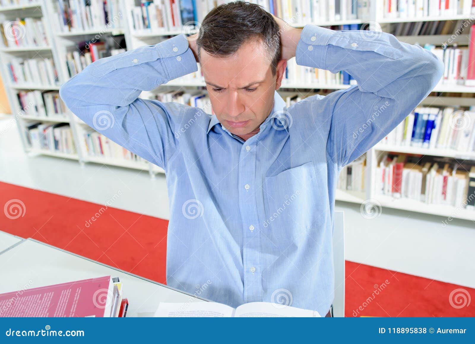 Man Reading Arms Behind Head Stock Photo - Image of library, shirt ...