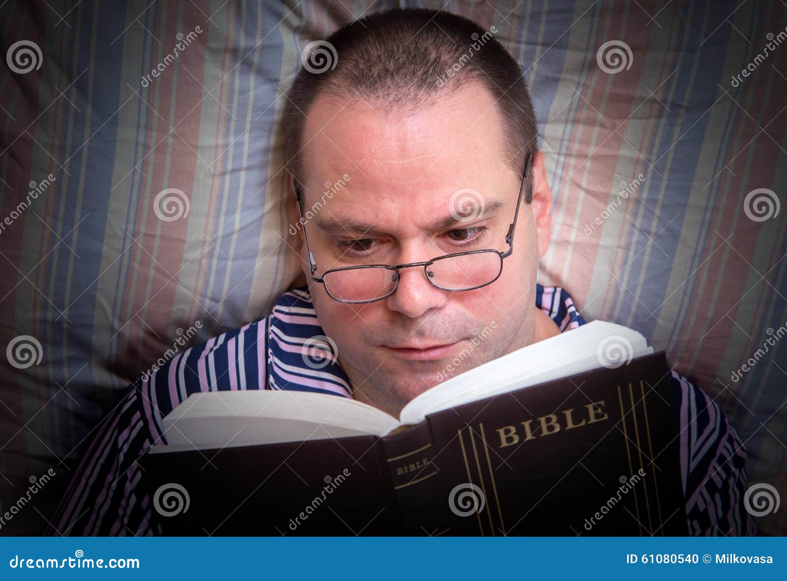 Man reading the Bible stock photo. Image of bedtime, bedroom - 61080540