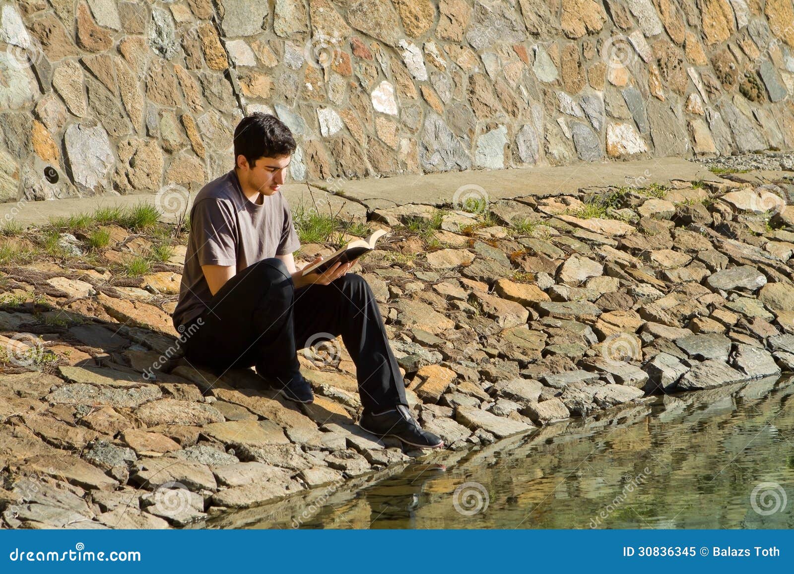Man Reading Bible by Lake stock image. Image of focus - 30836345