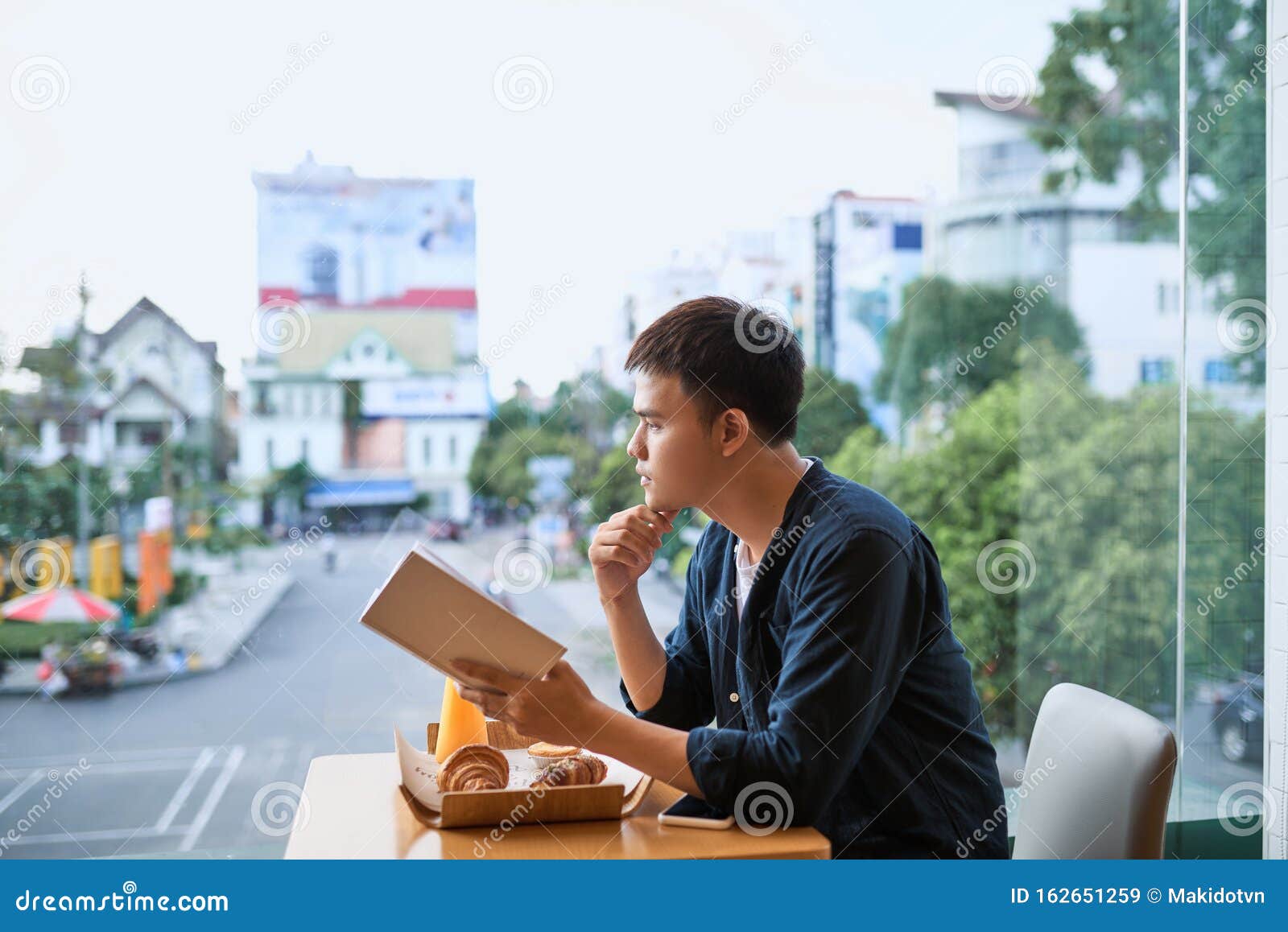 Man Reading a Book in a Coffee Shop. Stock Image - Image of bakery ...