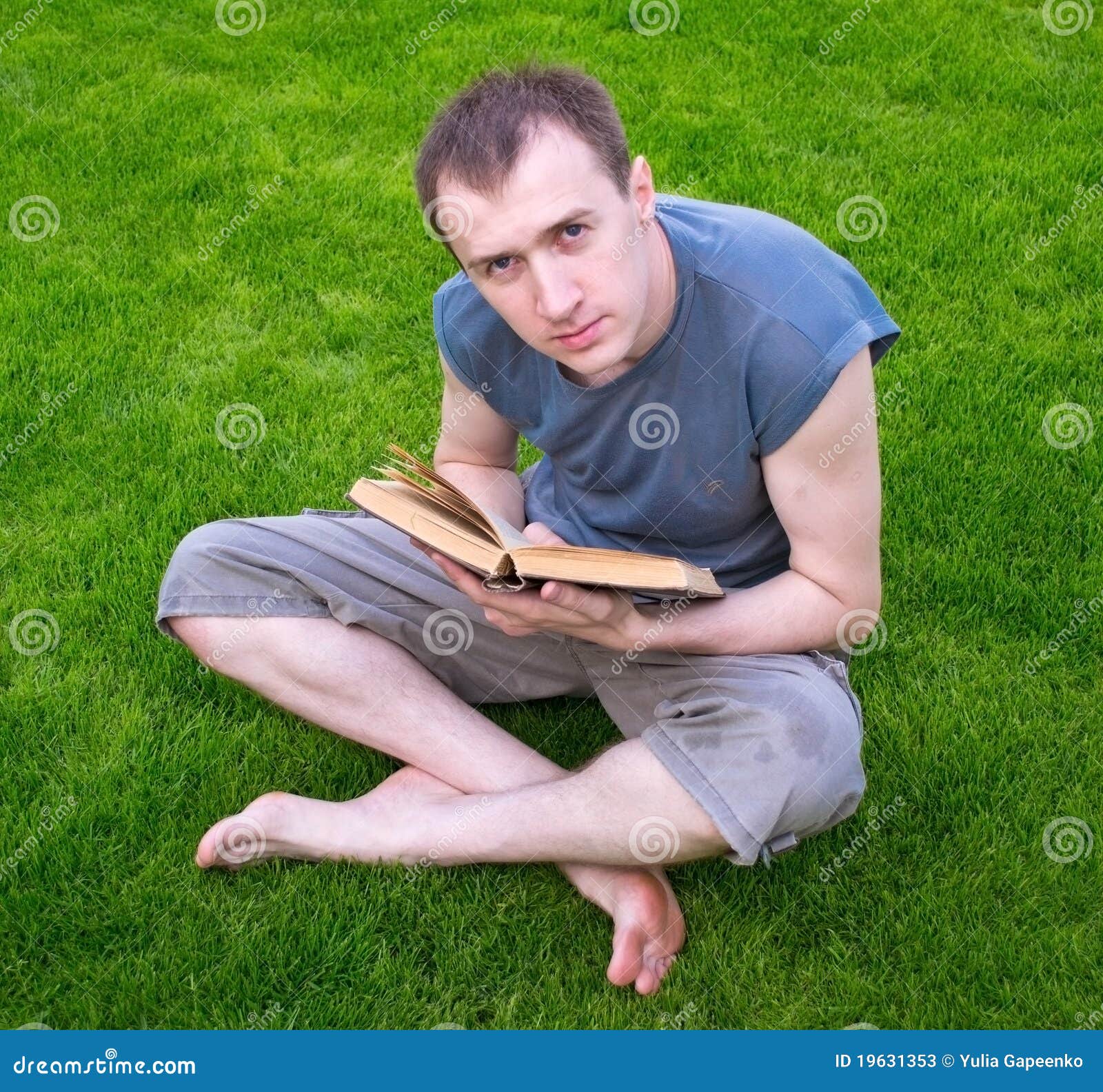 A Man Reading a Book on the Grass Stock Image - Image of learning ...