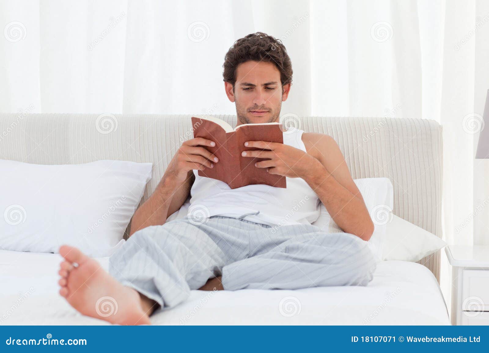 Man Reading a Book on His Bed Stock Image - Image of lifestyle ...