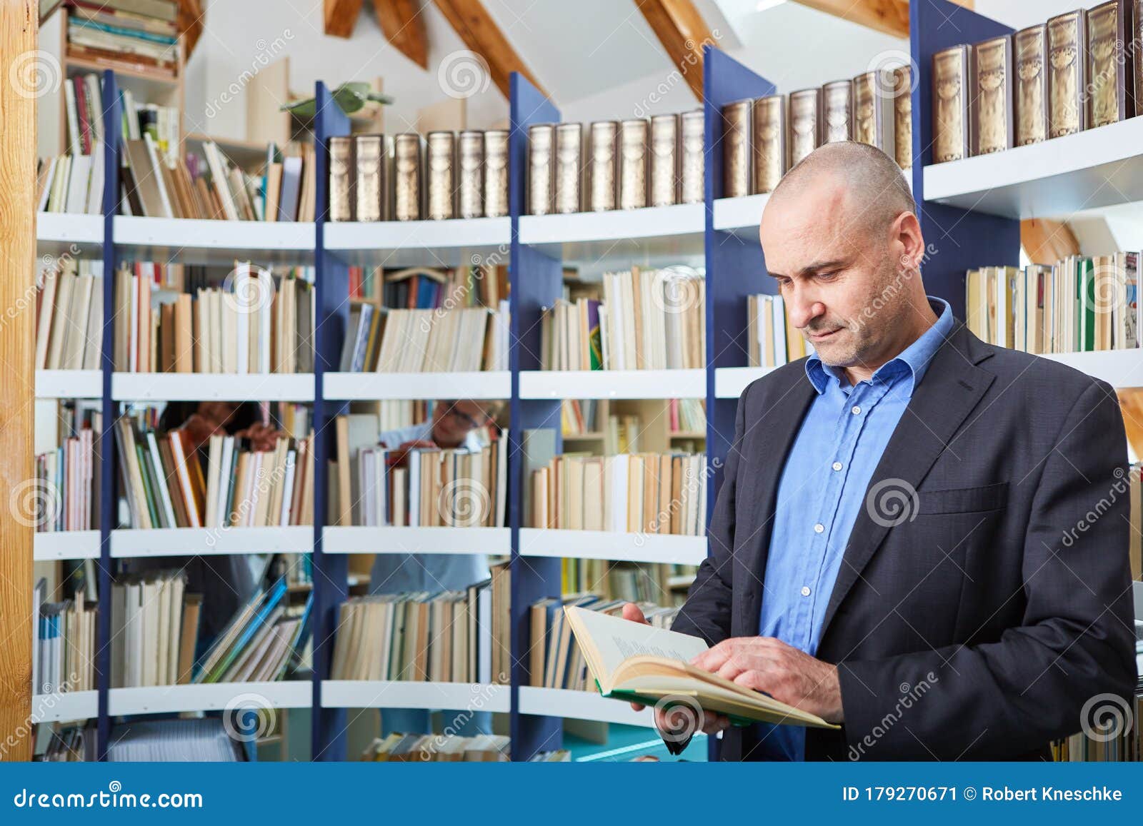 Man is Reading in a Book in a Library Stock Image - Image of ...