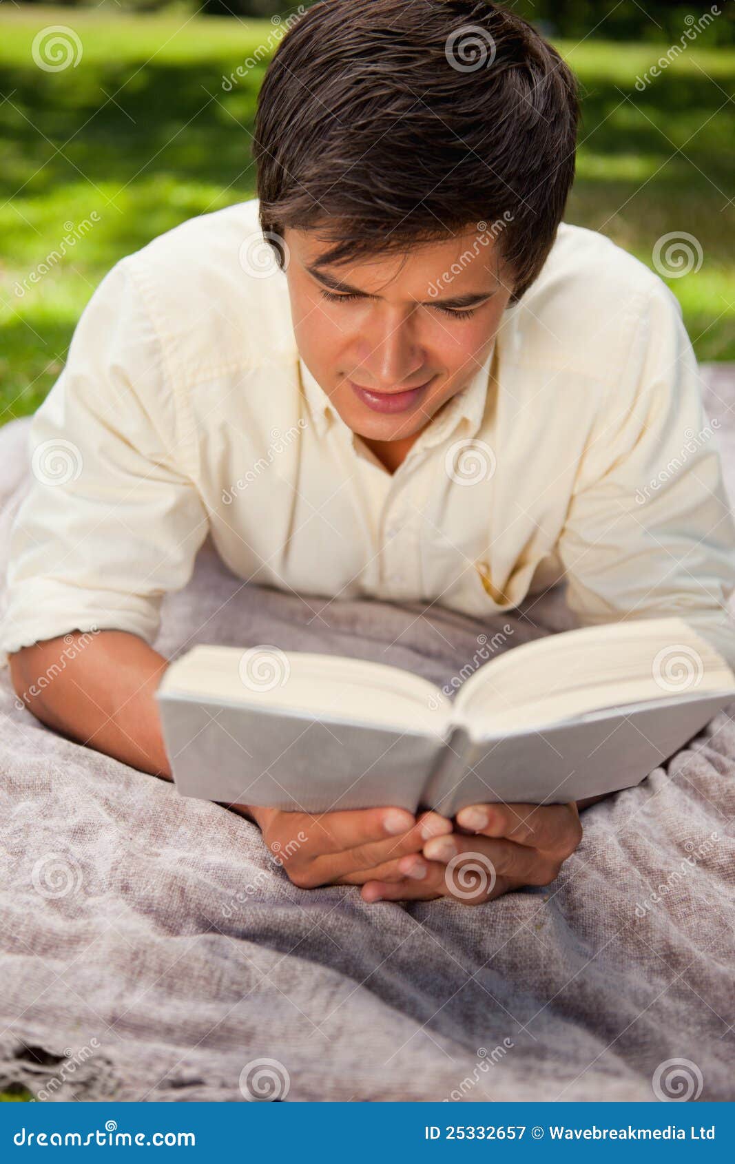 Man Reading Book while he Lies on a Blanket Stock Image - Image of ...