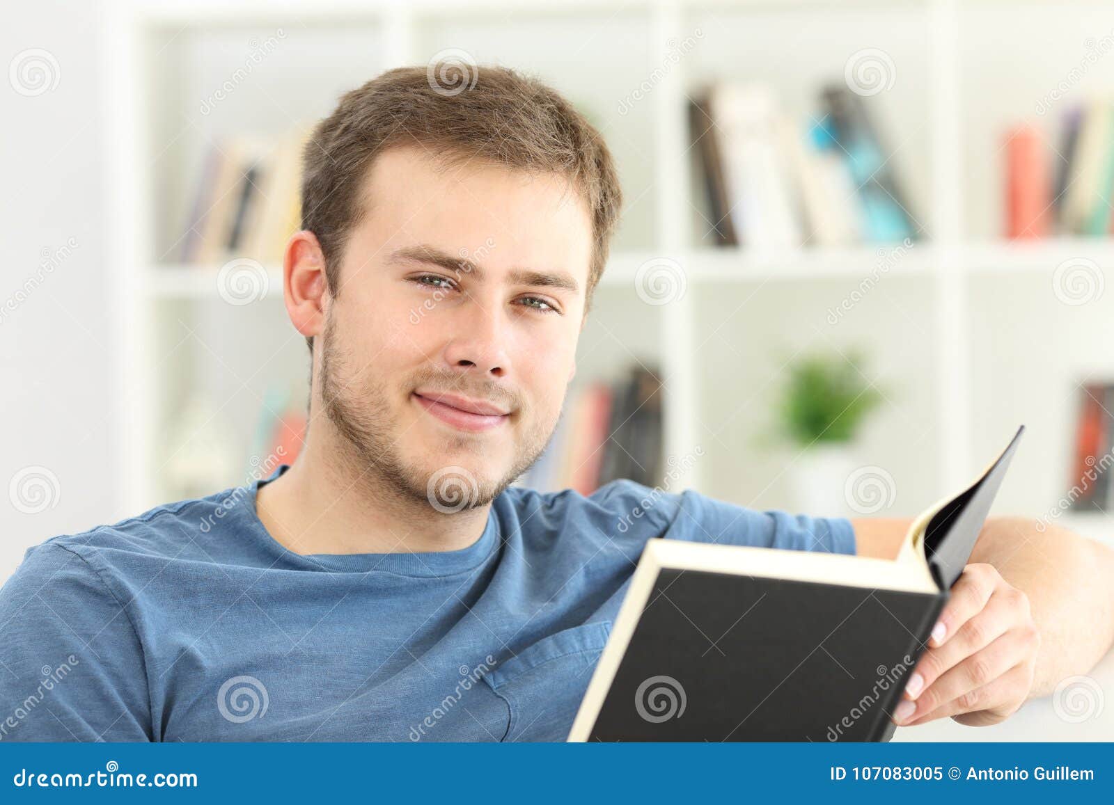 Man Reading a Book Looking at You Stock Image - Image of comfort, couch ...