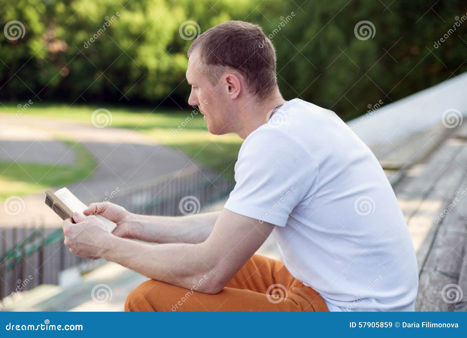 Man reading book outdoor stock image. Image of caucasian - 57905859
