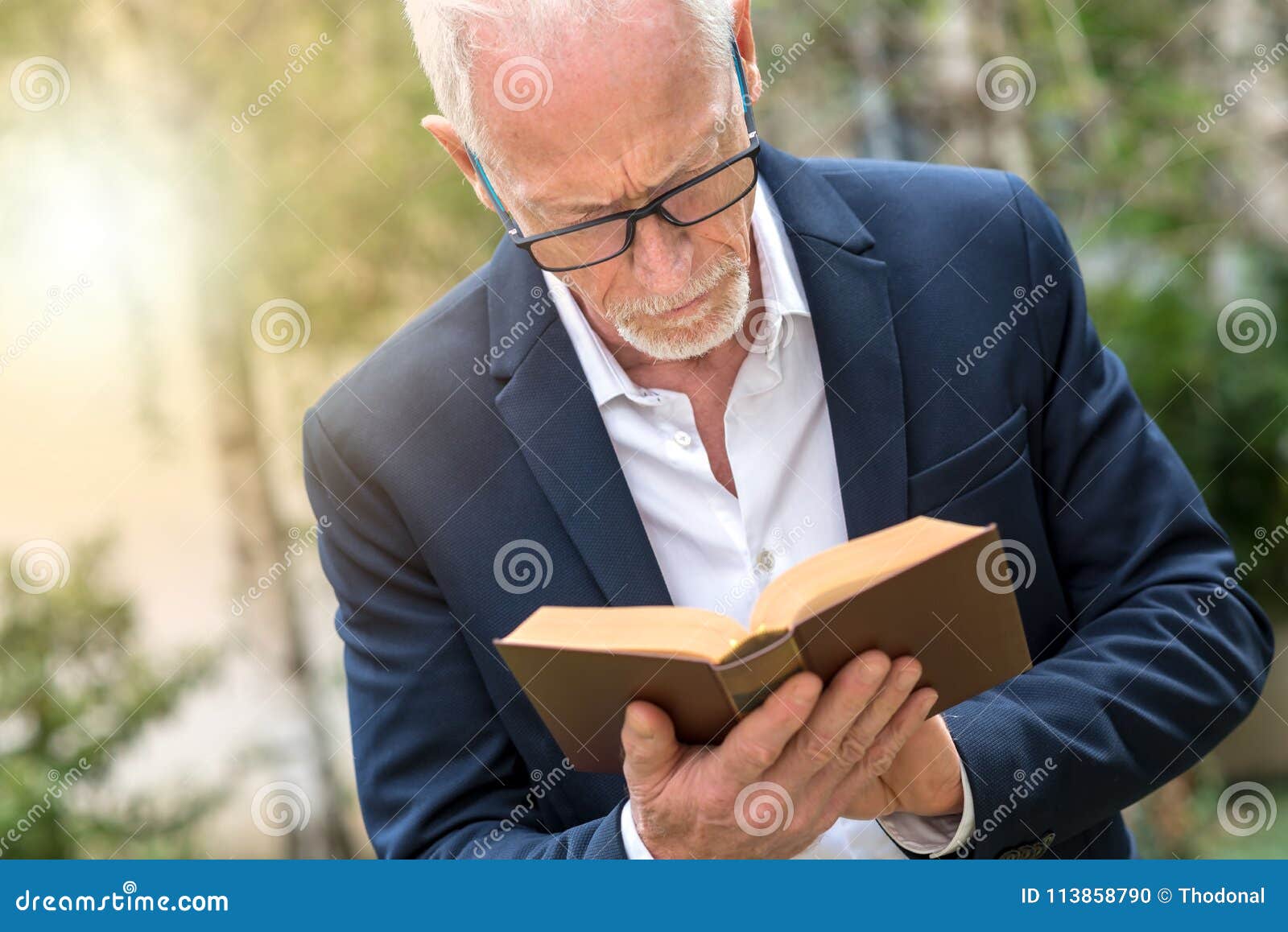 Man Reading a Book Outdoors, Light Effect Stock Photo - Image of ...