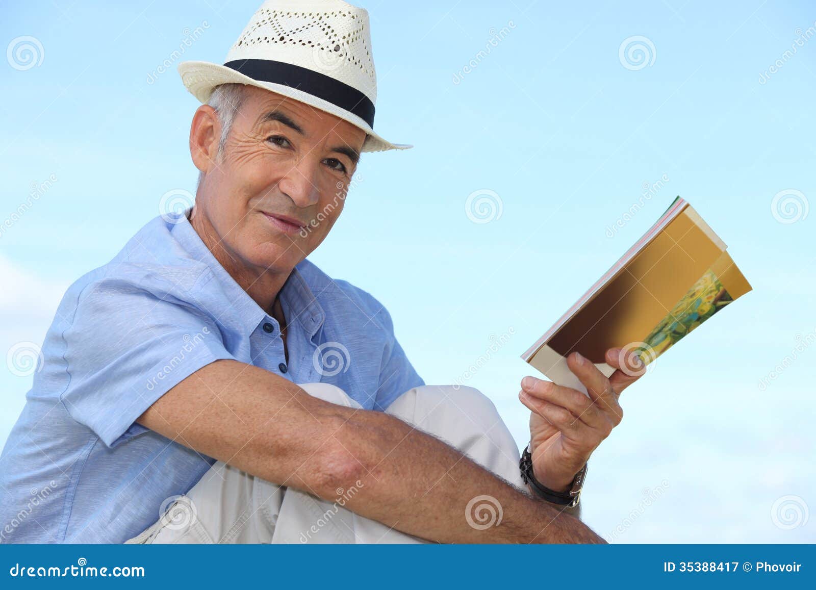 Man reading a book outside stock image. Image of blue - 35388417