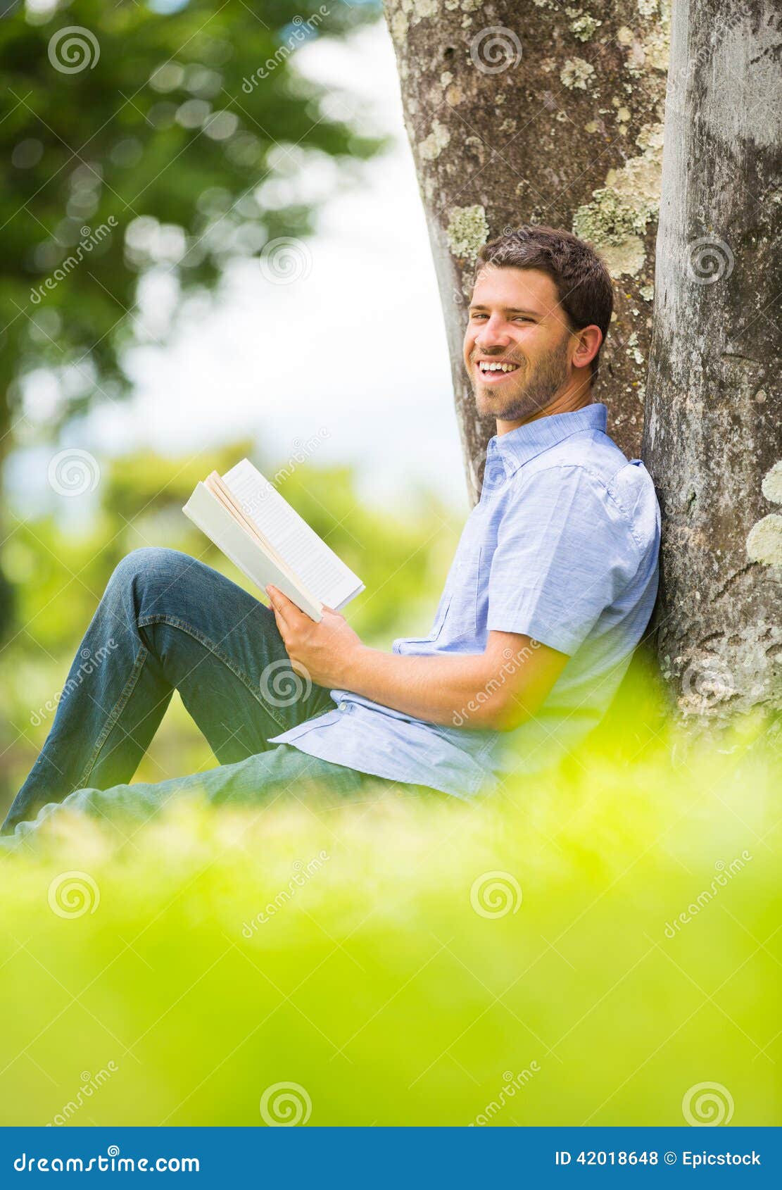 Man reading book in park stock photo. Image of education - 42018648