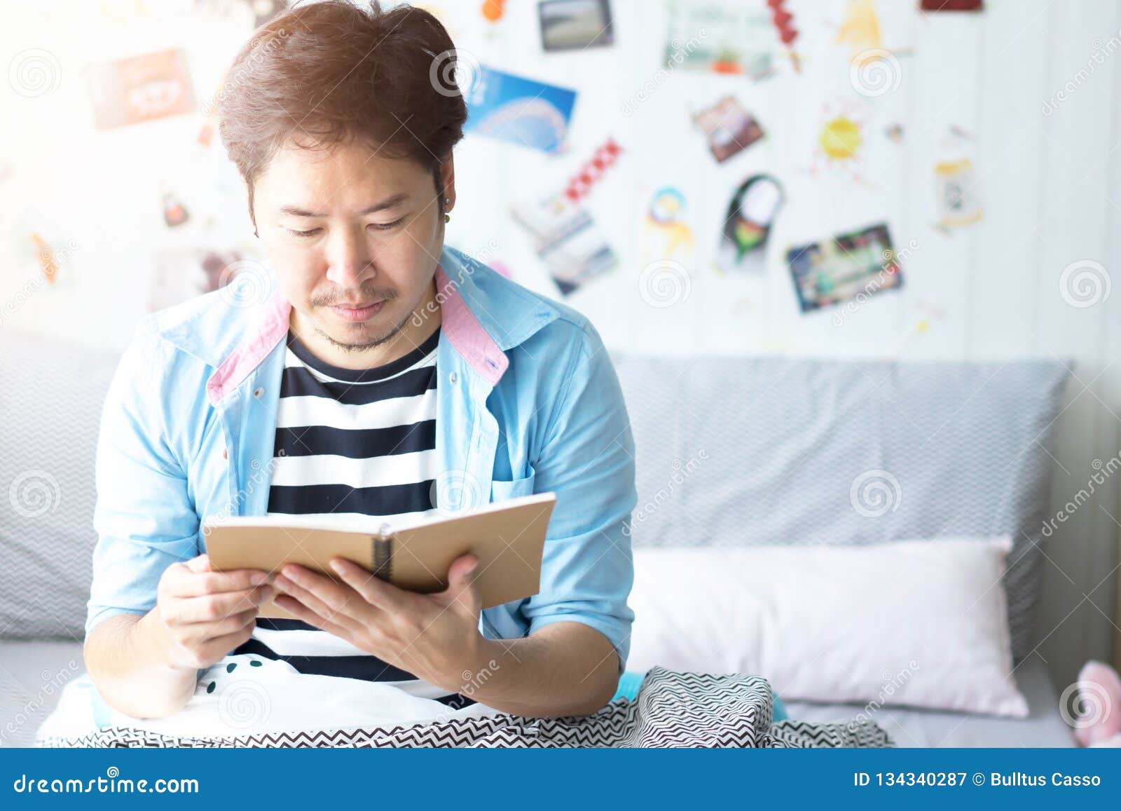 A Man Reading a Book for Relax on Bed in Bedroom Stock Image - Image of ...