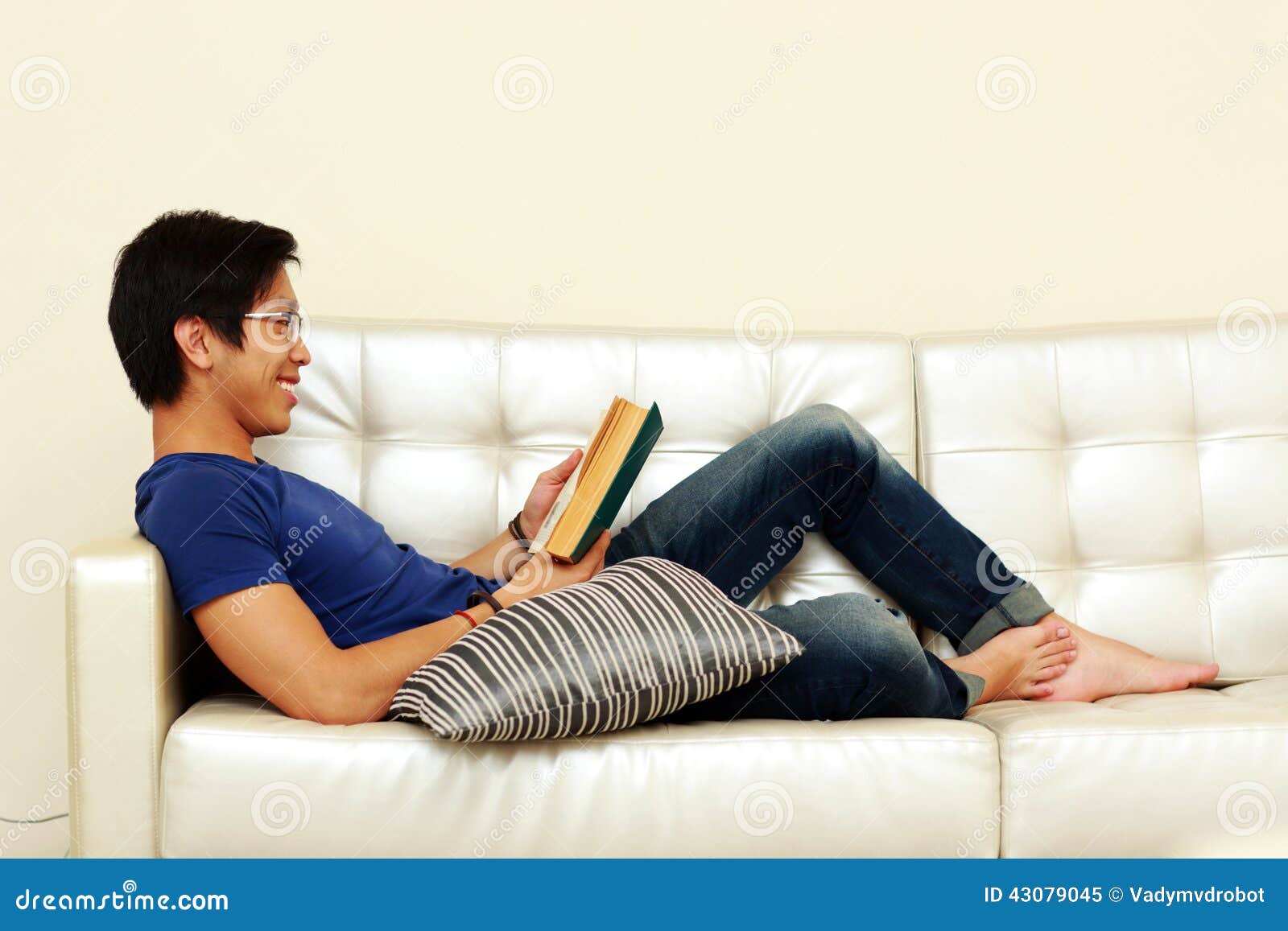 Man Reading a Book while Relaxing on Sofa Stock Image - Image of ...