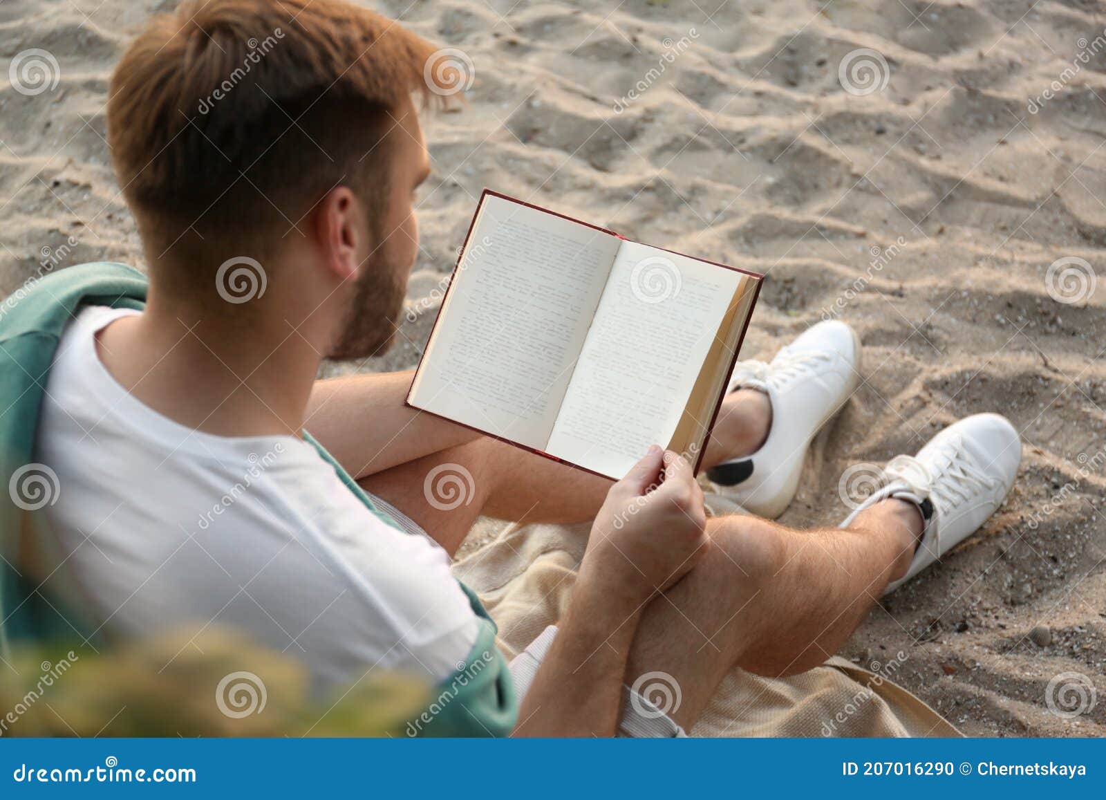 Young Man Reading Book on Sandy Beach, Back View Stock Photo - Image of ...