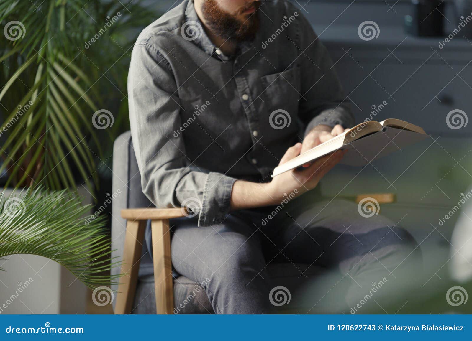 Man Reading Book while Sitting on Grey Armchair Stock Image - Image of ...