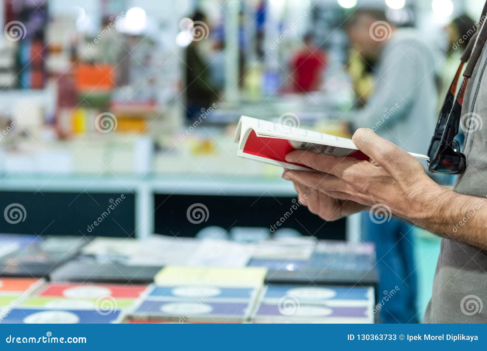 Man Reading a Book at the Stand in a Book Fair Stock Image - Image of ...