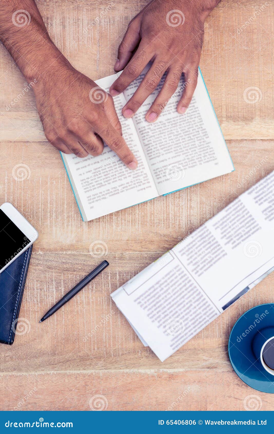 Man reading book on table stock photo. Image of finger - 65406806