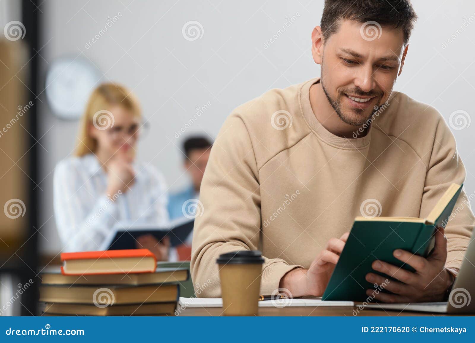 Man reading book at table stock photo. Image of coffee - 222170620