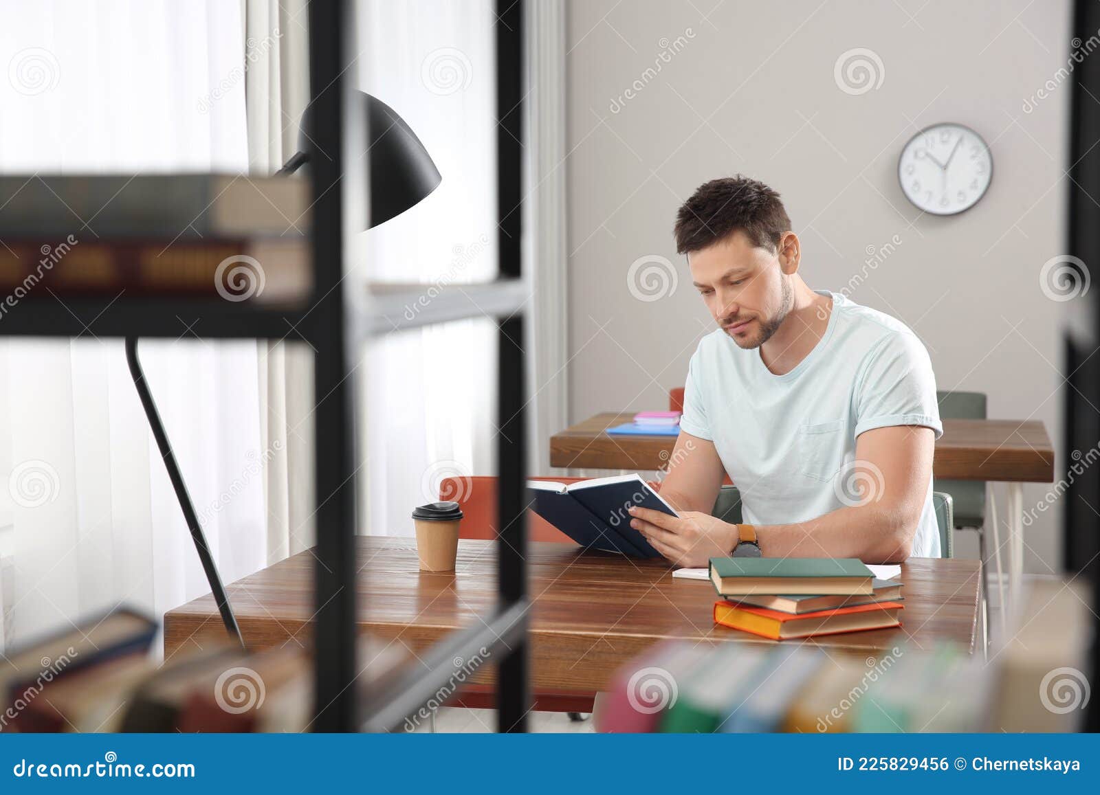 Man reading book at table stock photo. Image of academic - 225829456