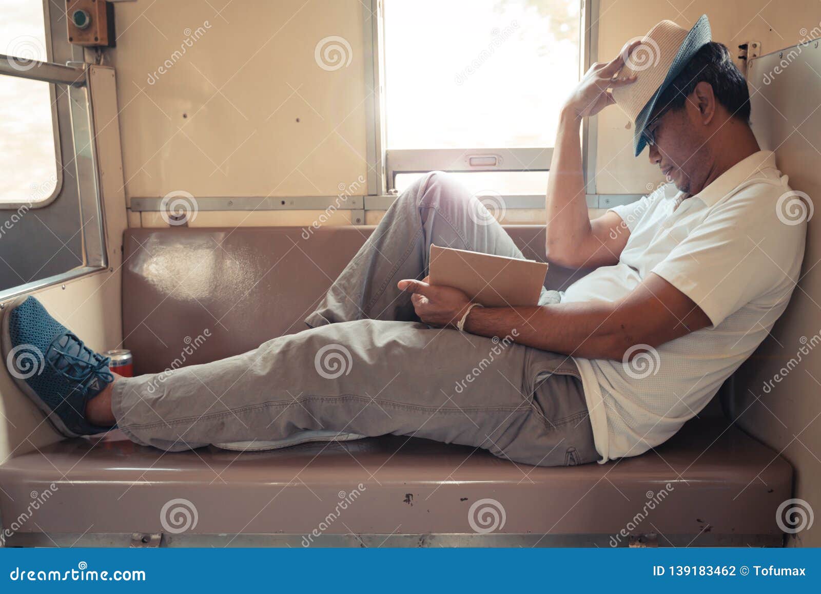 Man Reading Book on the Train Stock Photo - Image of book, reader ...