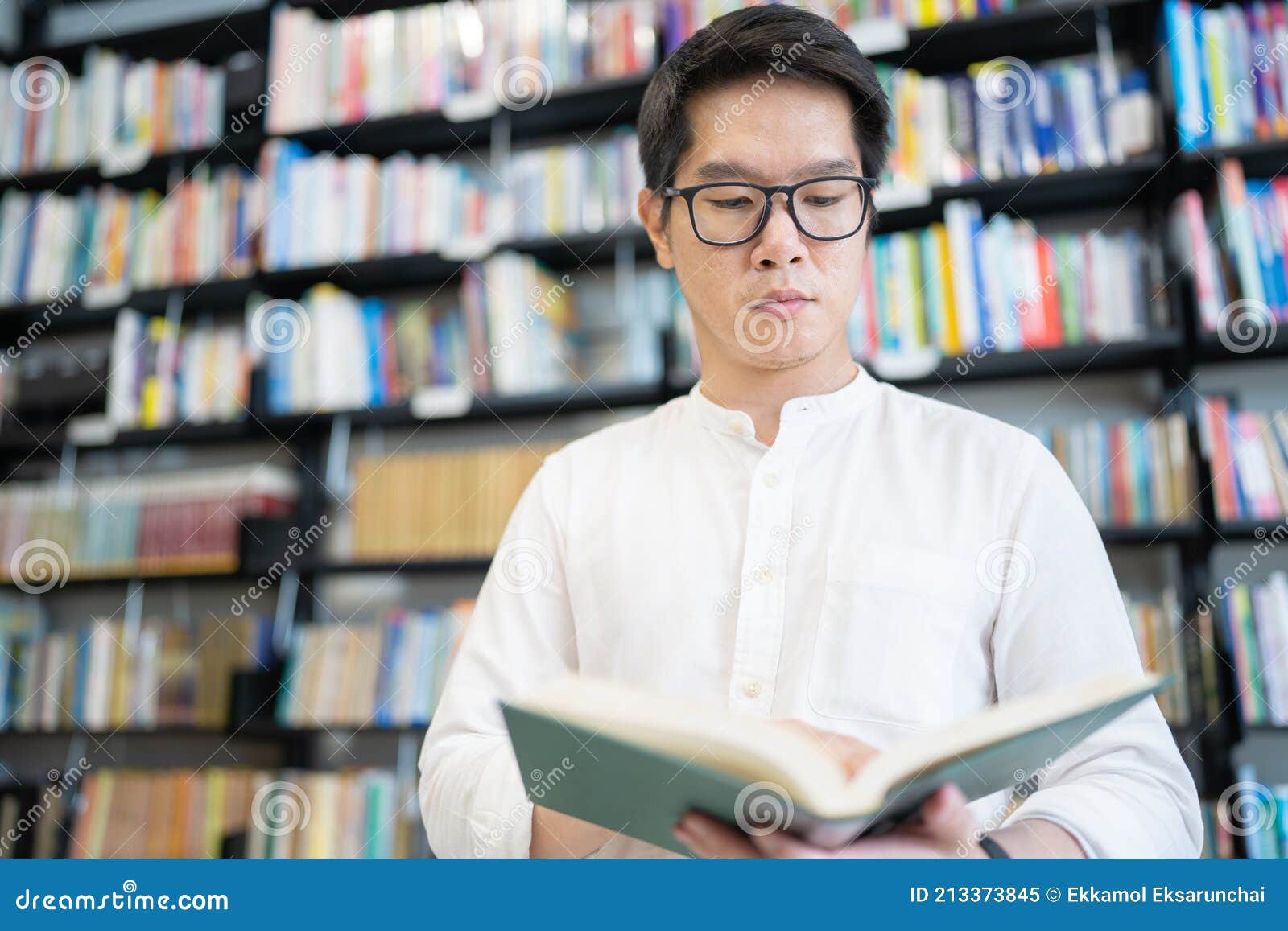 A Man is Reading a Book in the University Library Stock Image - Image ...