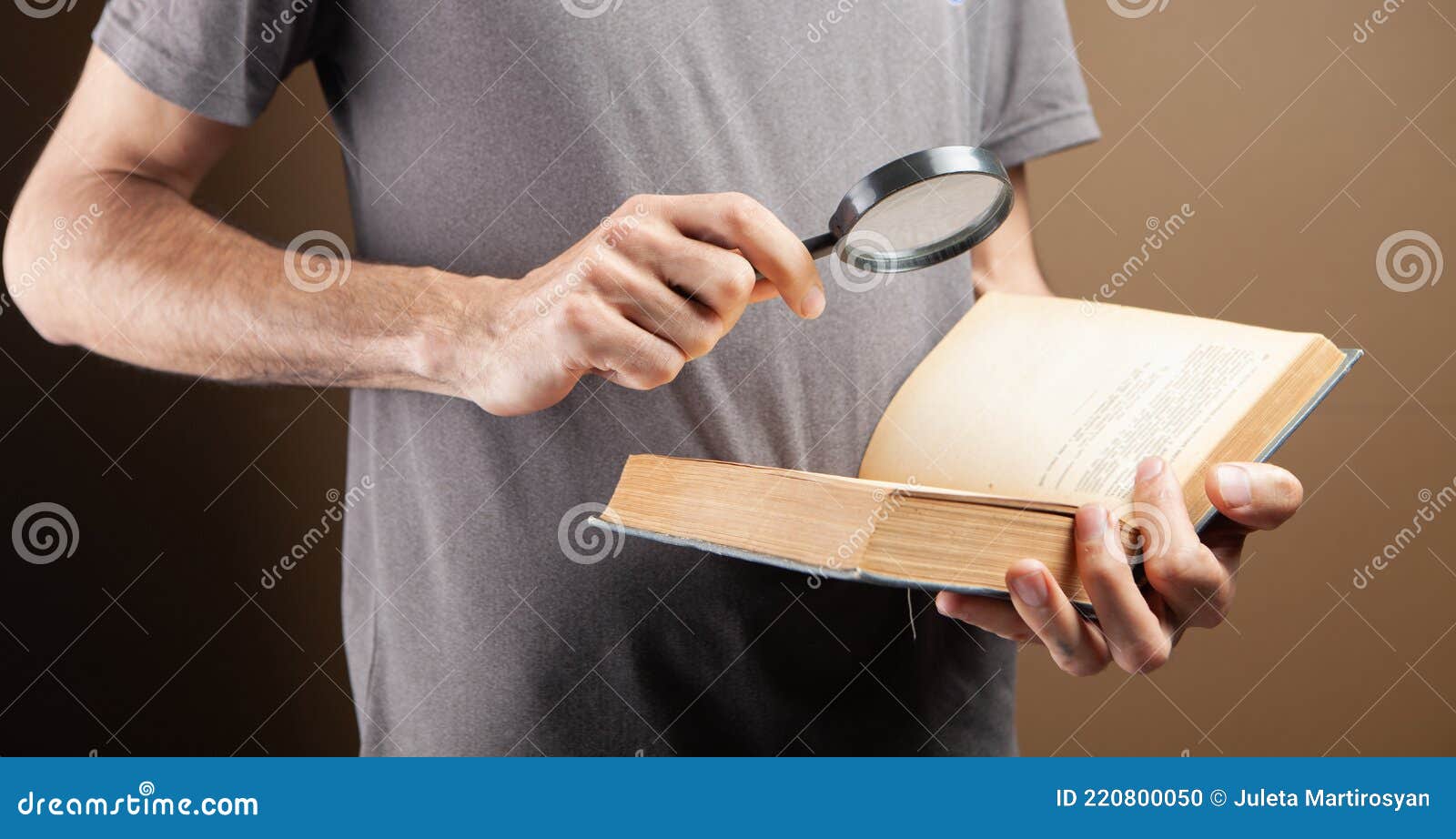 Man Reading a Book Using a Magnifying Glass Stock Photo - Image of ...