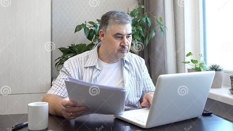 Man Reading Documents at Work Desk Stock Photo - Image of businessman ...