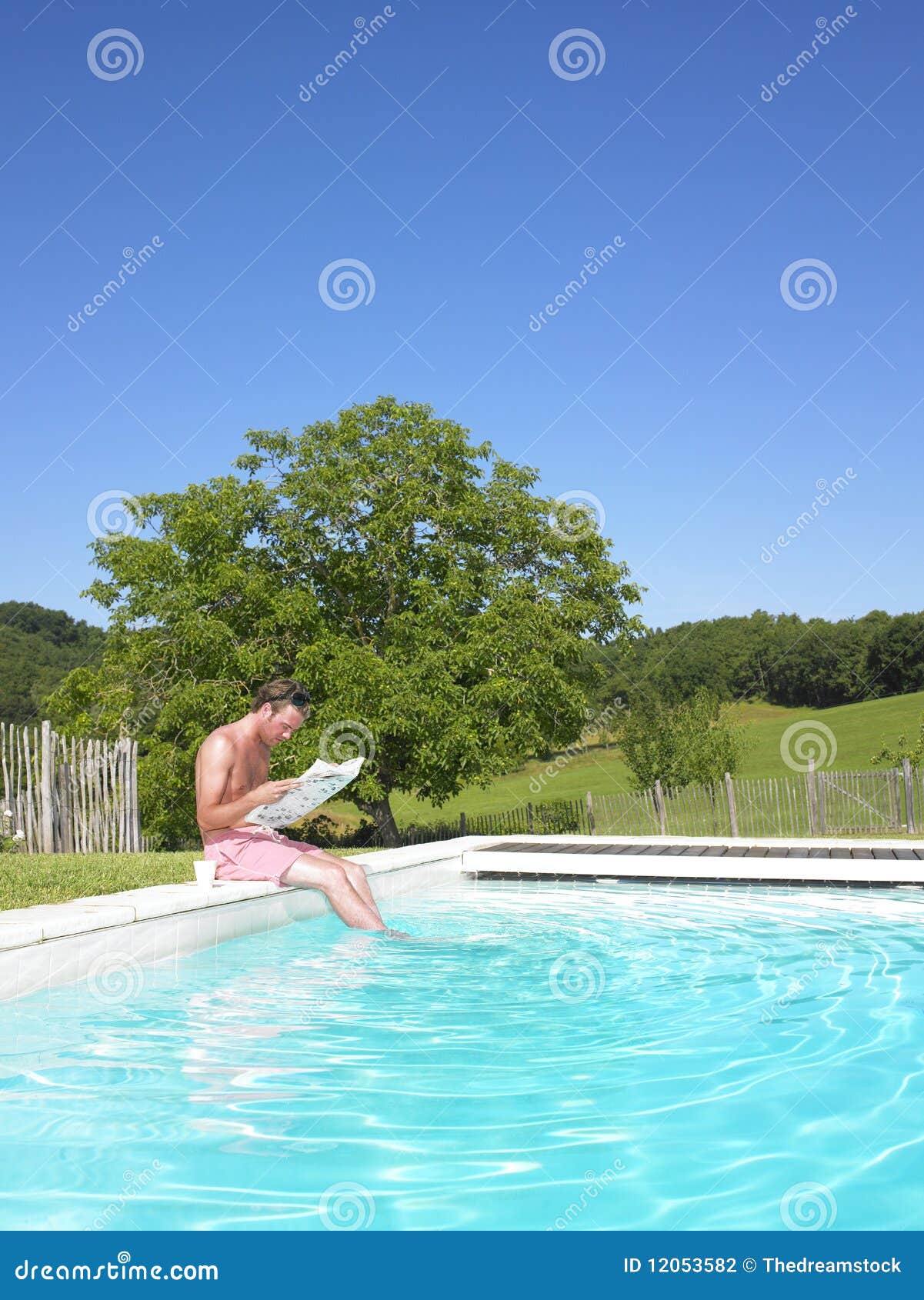 Man Reading at Edge of Swimming Pool Stock Photo - Image of lifestyle ...
