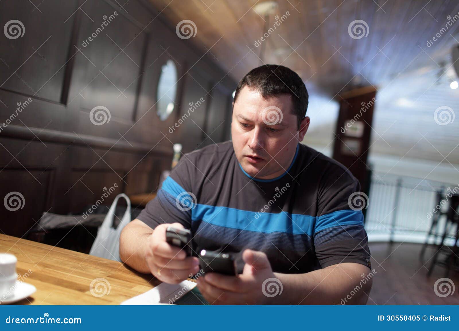 Man reading email in a pub stock image. Image of human - 30550405