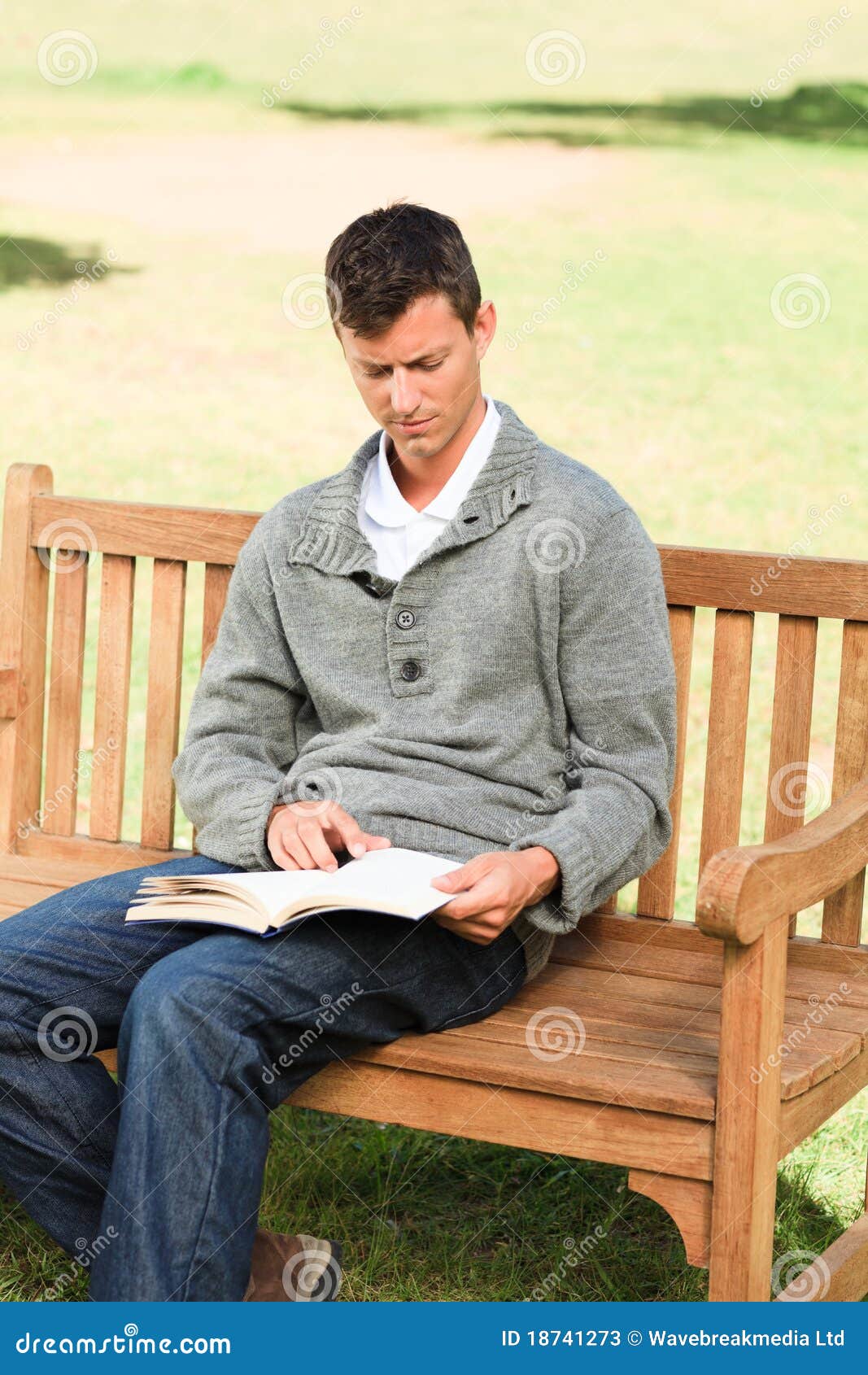 Man Reading His Book on the Bench Stock Image - Image of adult, outside ...