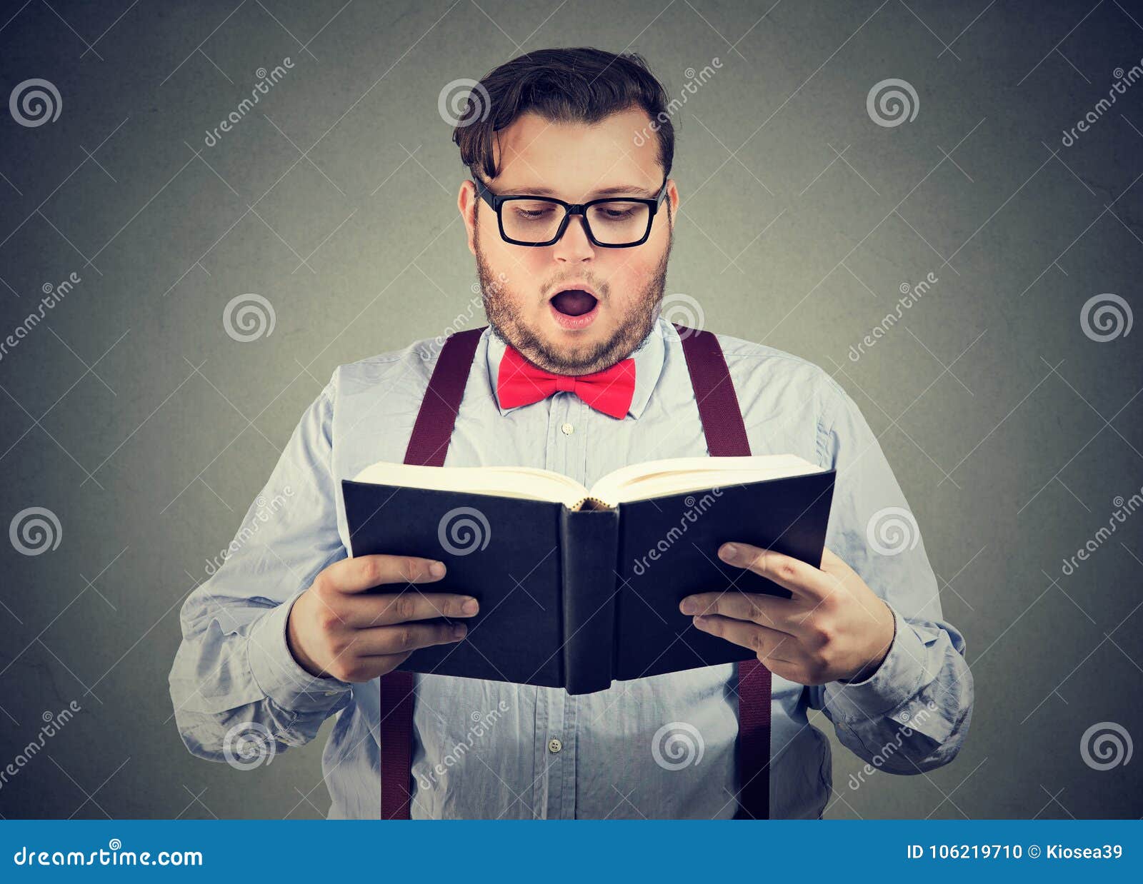 Man Reading Interesting Book with Shocked Face Expression Stock Photo ...