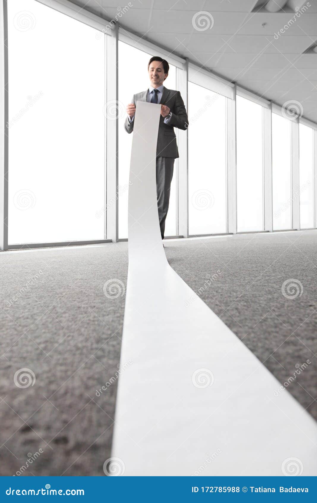 Man reading a long paper stock photo. Image of note - 172785988