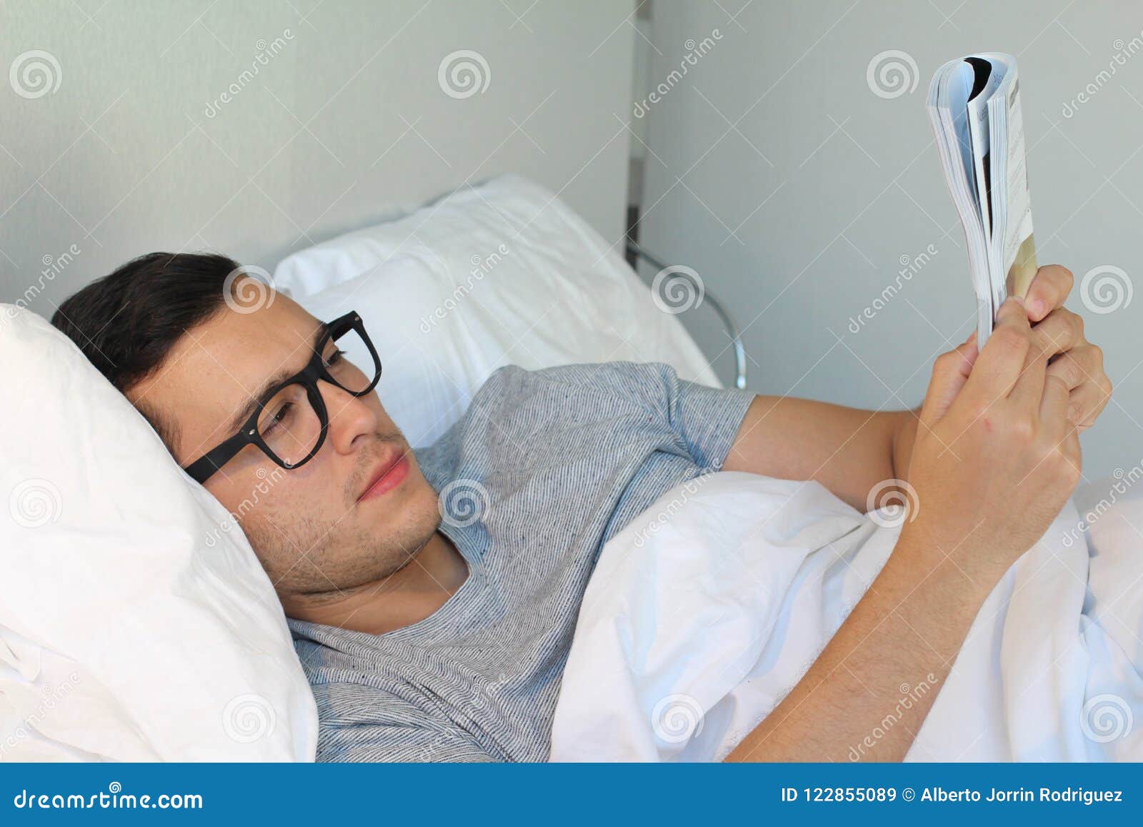 Man Reading a Magazine in Bed Stock Image - Image of focused, leisure ...