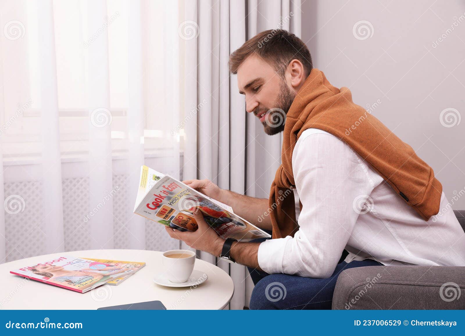 Handsome Man Reading Magazine Near Window at Home Stock Image - Image ...