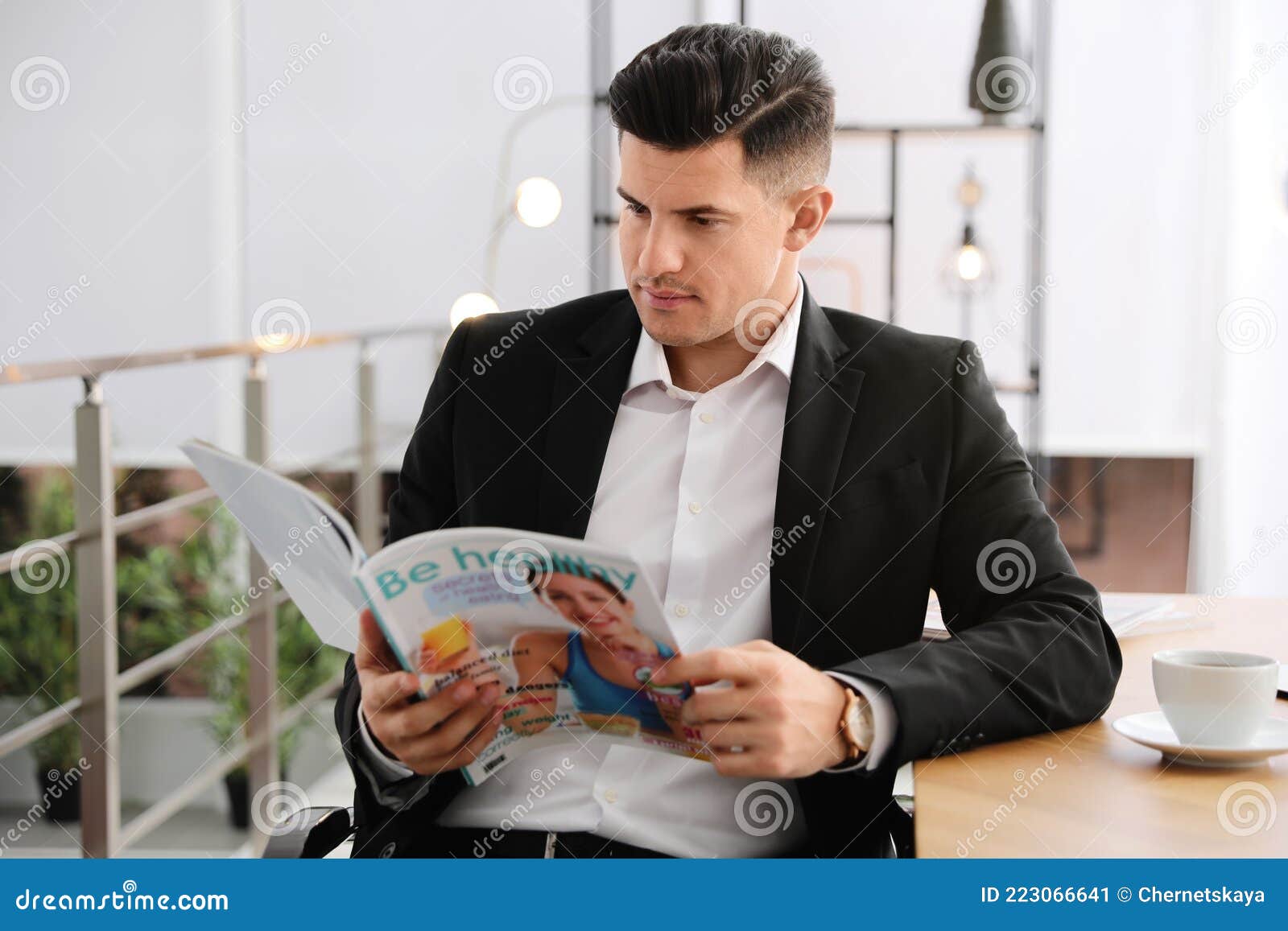 Man Reading Magazine at Table Stock Image - Image of modern, business ...