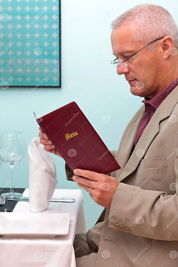 Man Reading a Menu in a Restaurant Vertical Stock Image - Image of ...