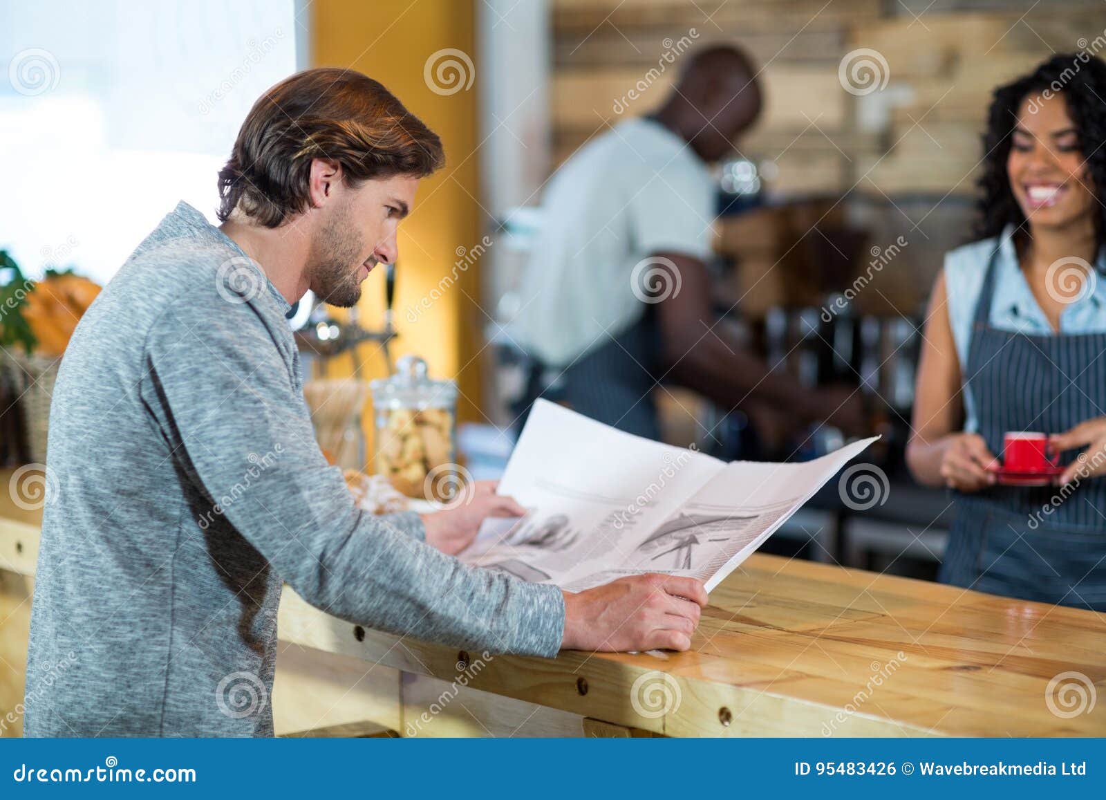Man Reading Newspaper at Counter Stock Photo - Image of counter ...