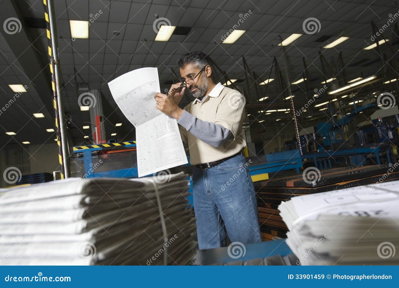Man Reading Newspaper in Factory Stock Image - Image of manufacturing ...