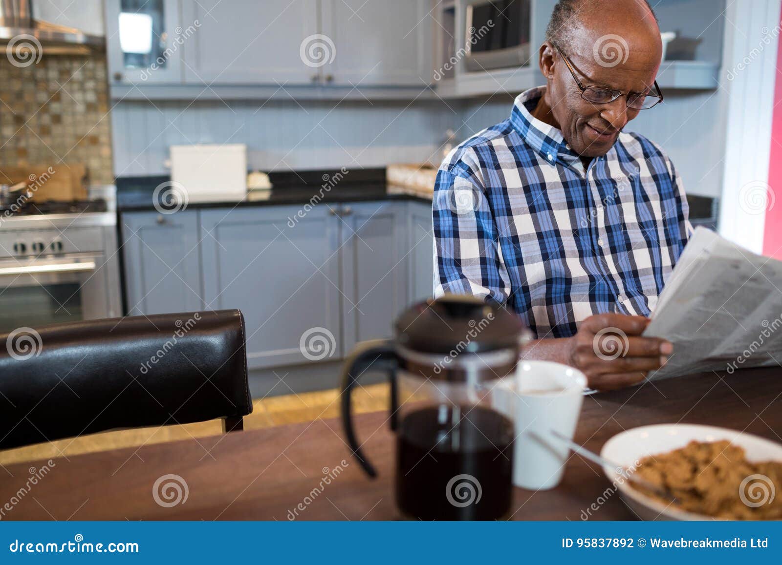 Man Reading Newspaper while Having Breakfast Stock Photo - Image of ...
