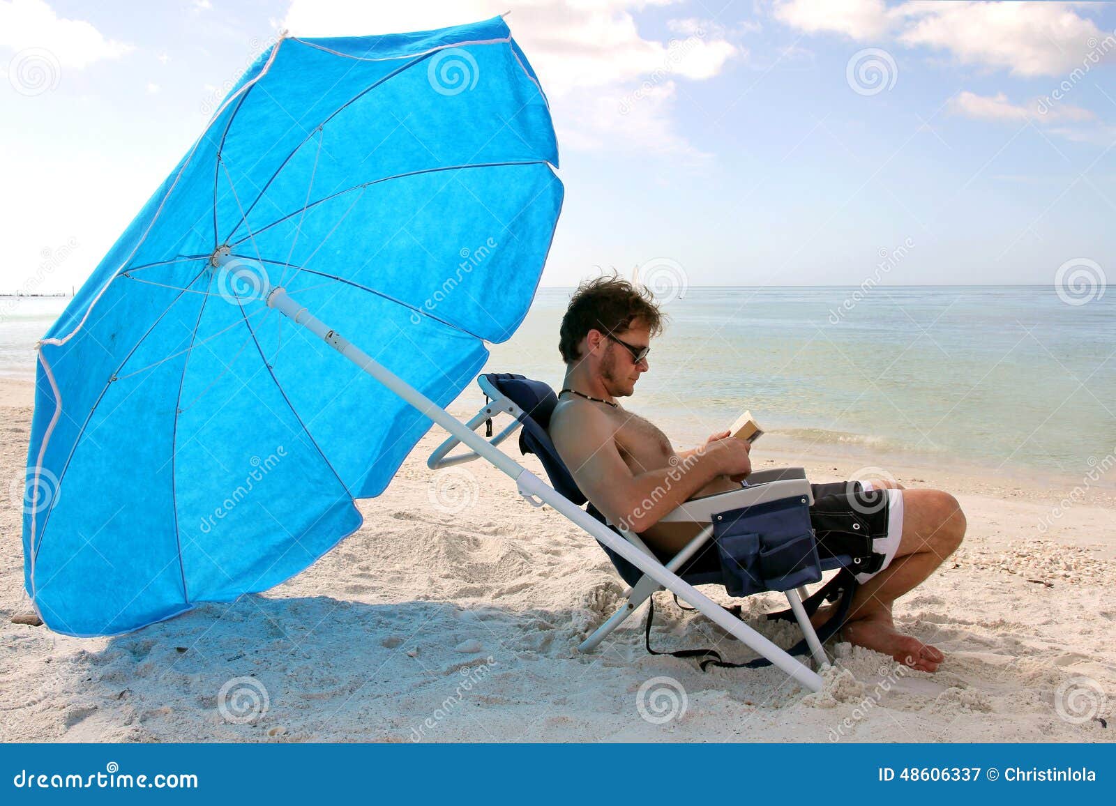 Man Reading by Ocean Under Beach Umbrella Stock Image - Image of chair ...