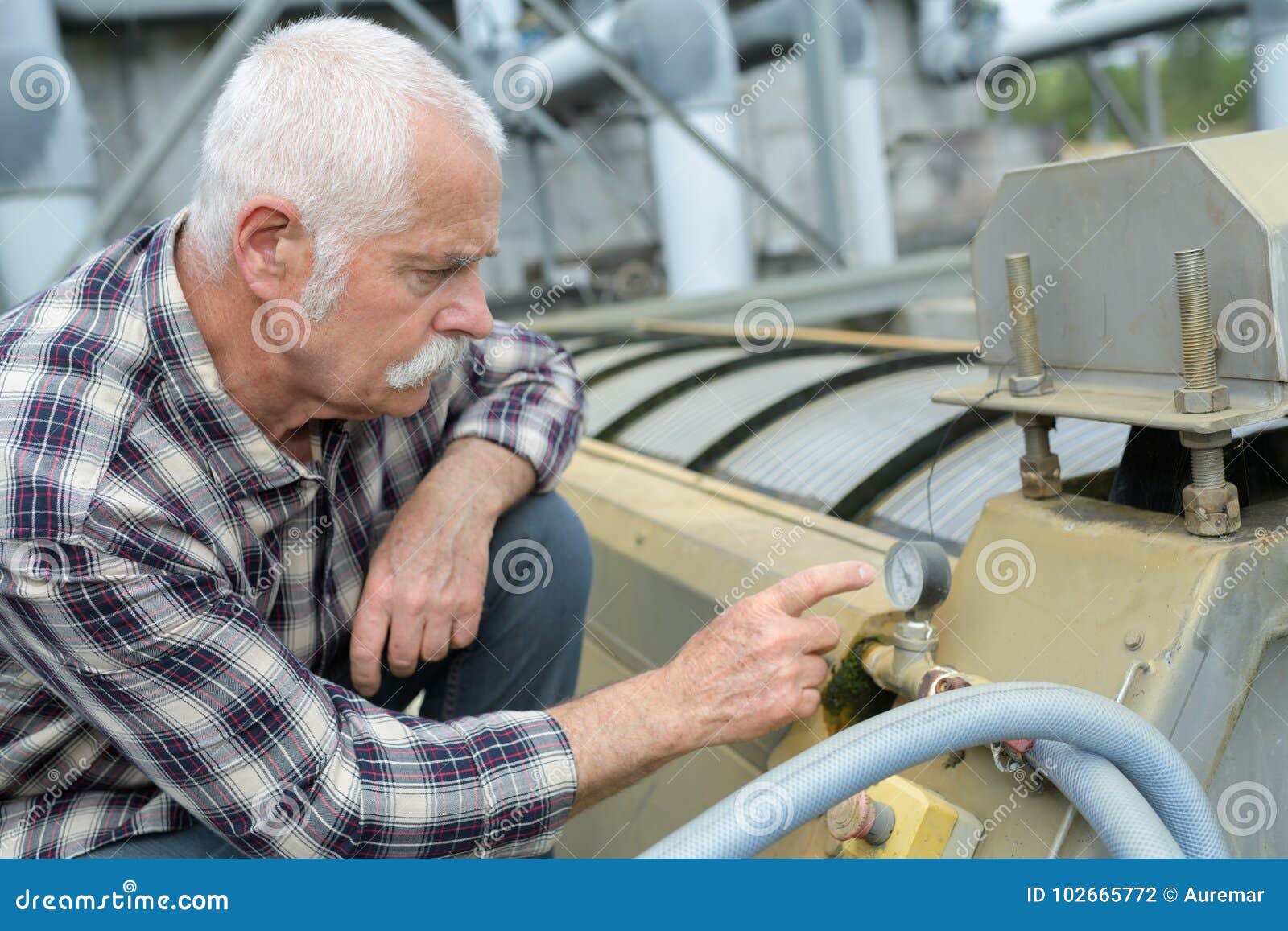 Man reading pressure gauge stock photo. Image of pump - 102665772
