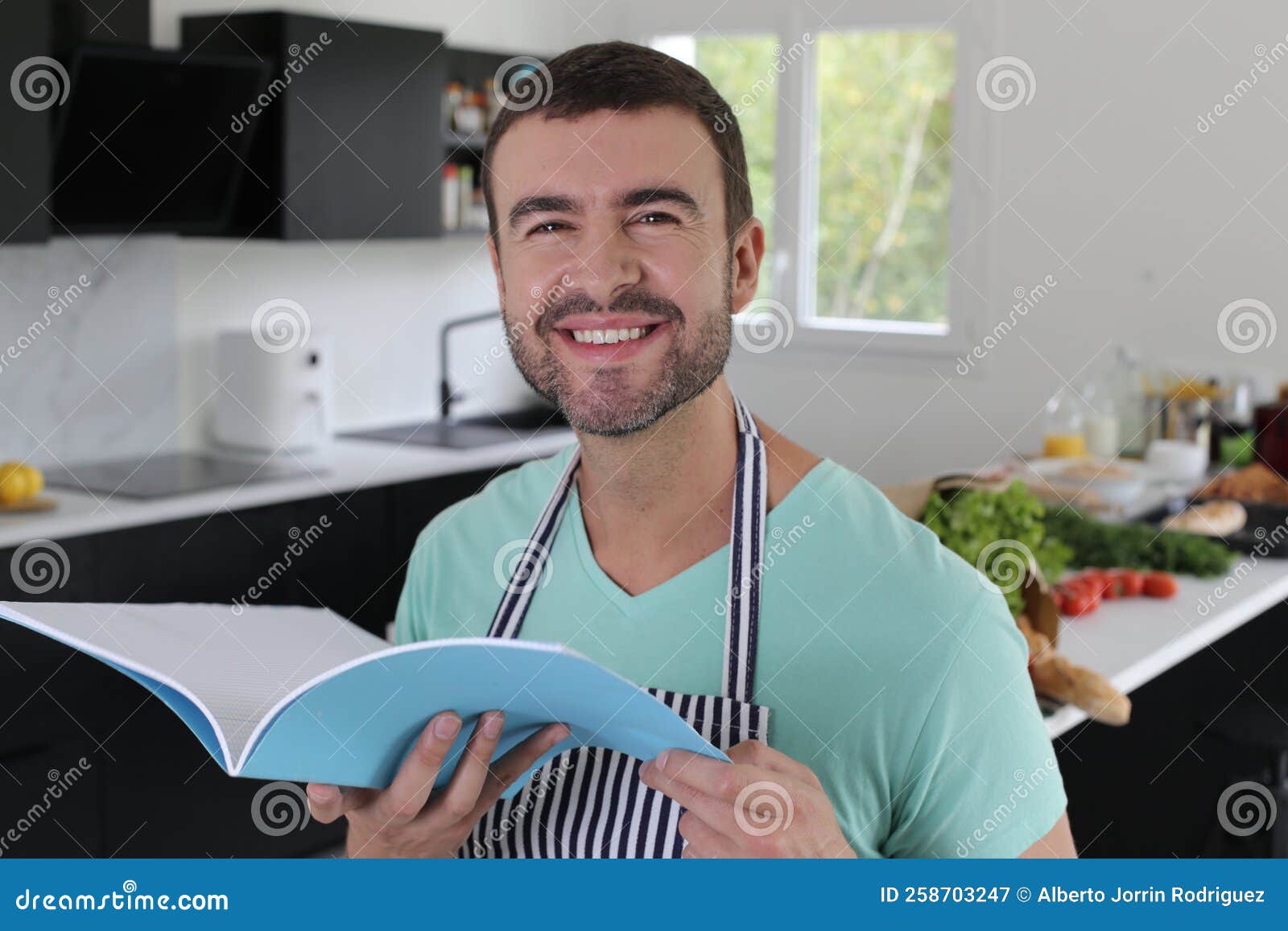 Man Reading Some Notes before Making Some Food in the Kitchen Stock ...