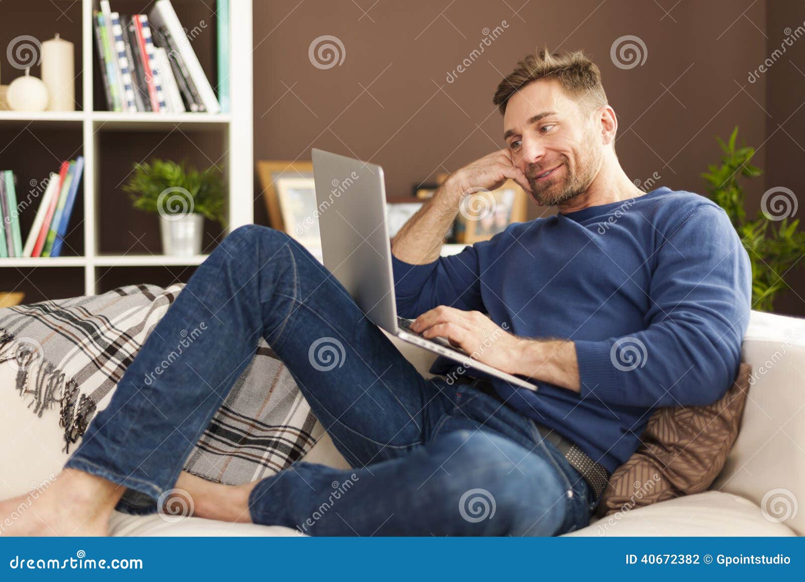 Man Reading Something on Laptop Stock Photo - Image of surf, home: 40672382