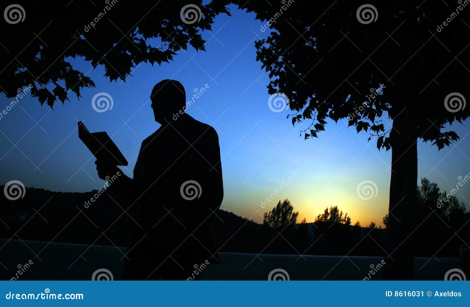 Man reading in the sunset stock image. Image of silhouette - 8616031