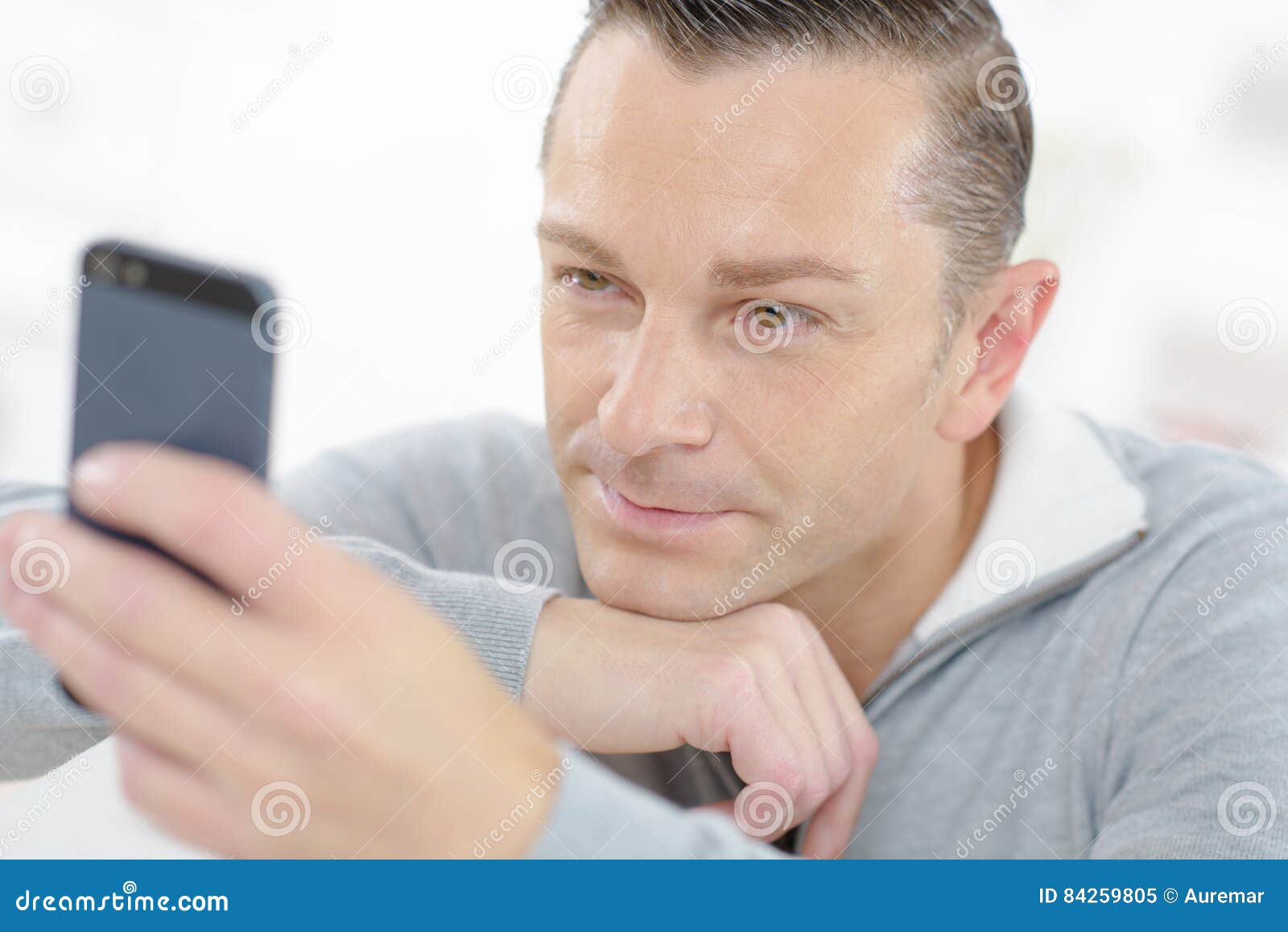 Man reading text message stock image. Image of holding - 84259805