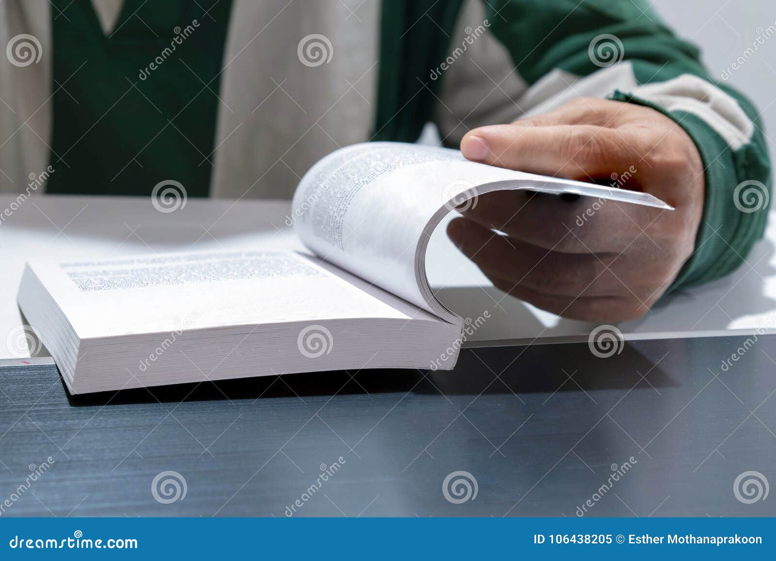 A Man is Ready a Book on the Table Stock Image - Image of laptop ...