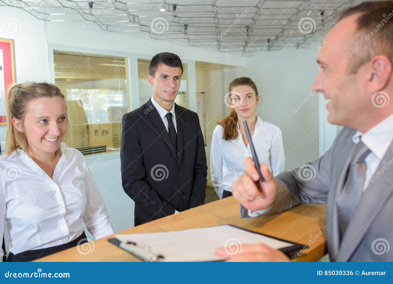 Man at Reception Hotel with Workers Stock Photo - Image of receptionist ...