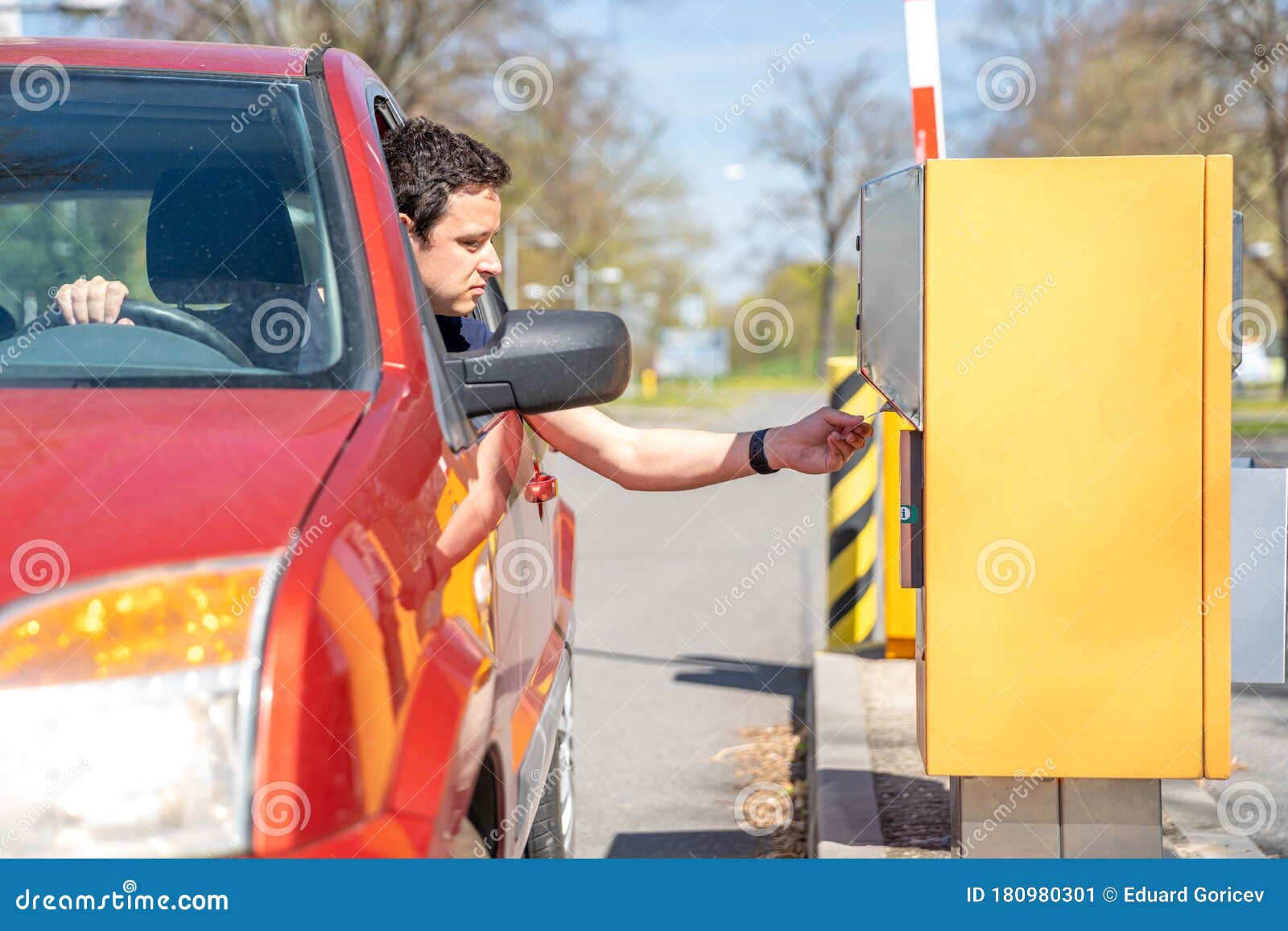 A Man in a Red Car Gets a Ticket in a Parking Meter Stock Image - Image ...