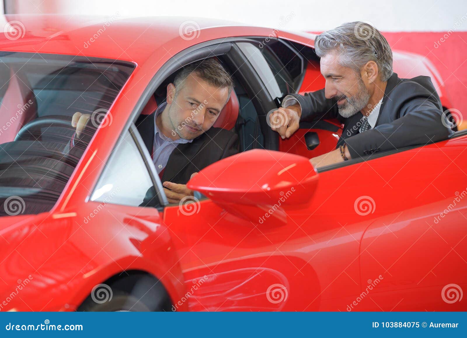 Man in red car in showroom stock image. Image of driver - 103884075