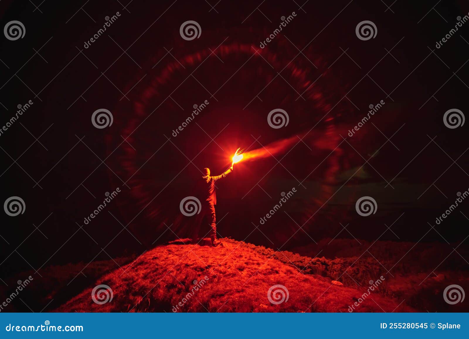 The Man with a Red Firework Stick Standing on a Mountain. Evening Night ...