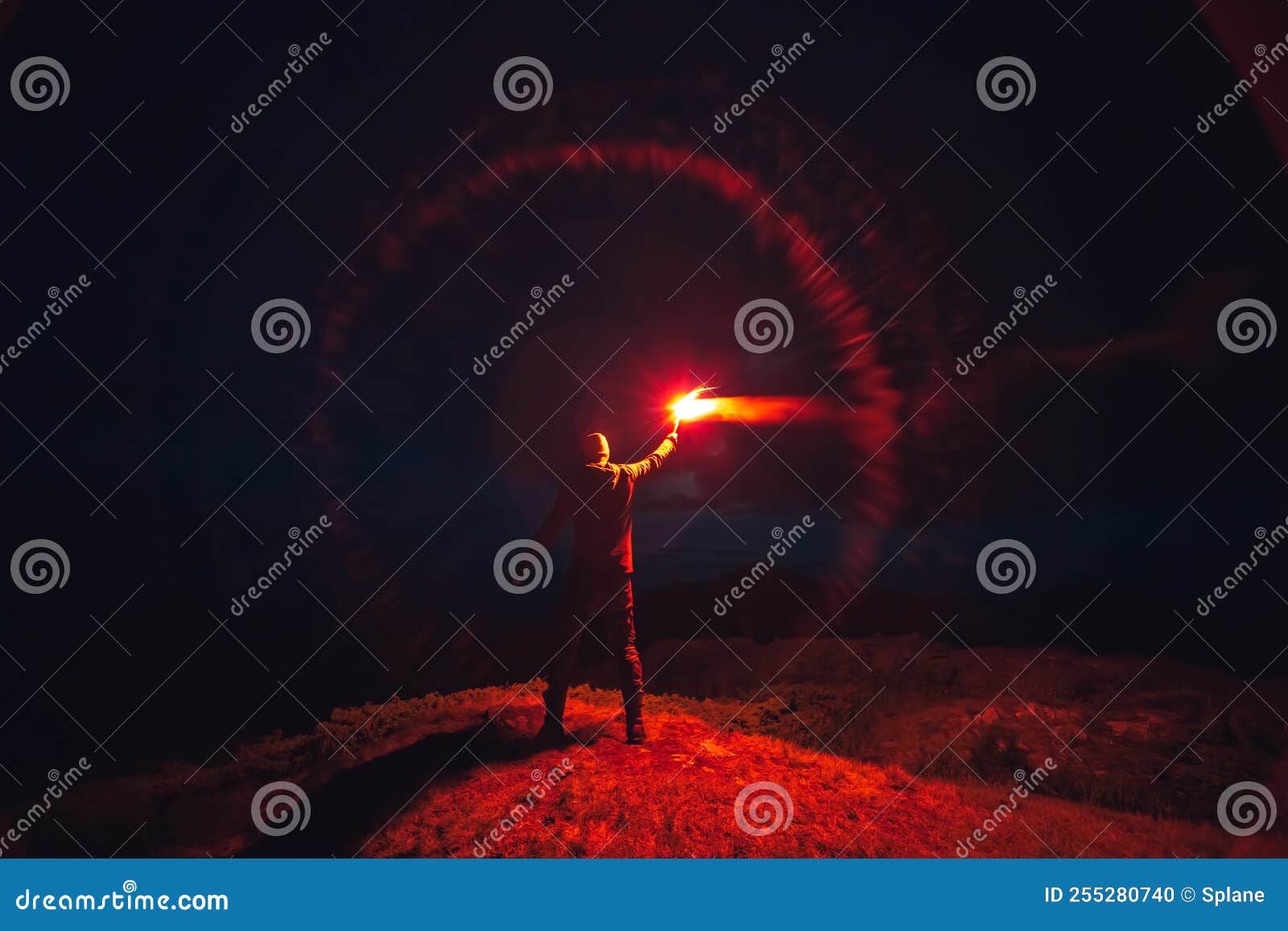 The Man with a Red Firework Stick Standing on a Mountain. Evening Night ...